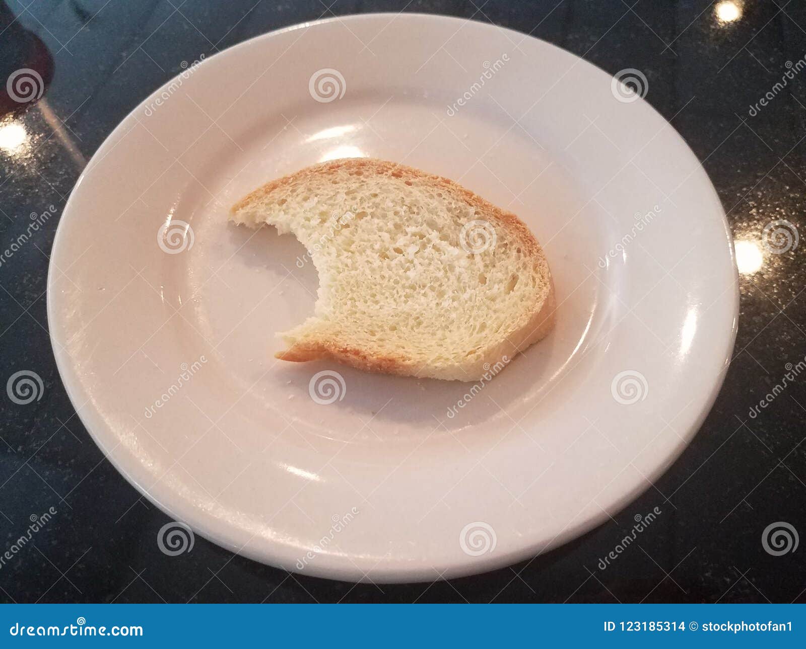 Bitten Bread on a White Plate Stock Photo - Image of baked, bitten ...