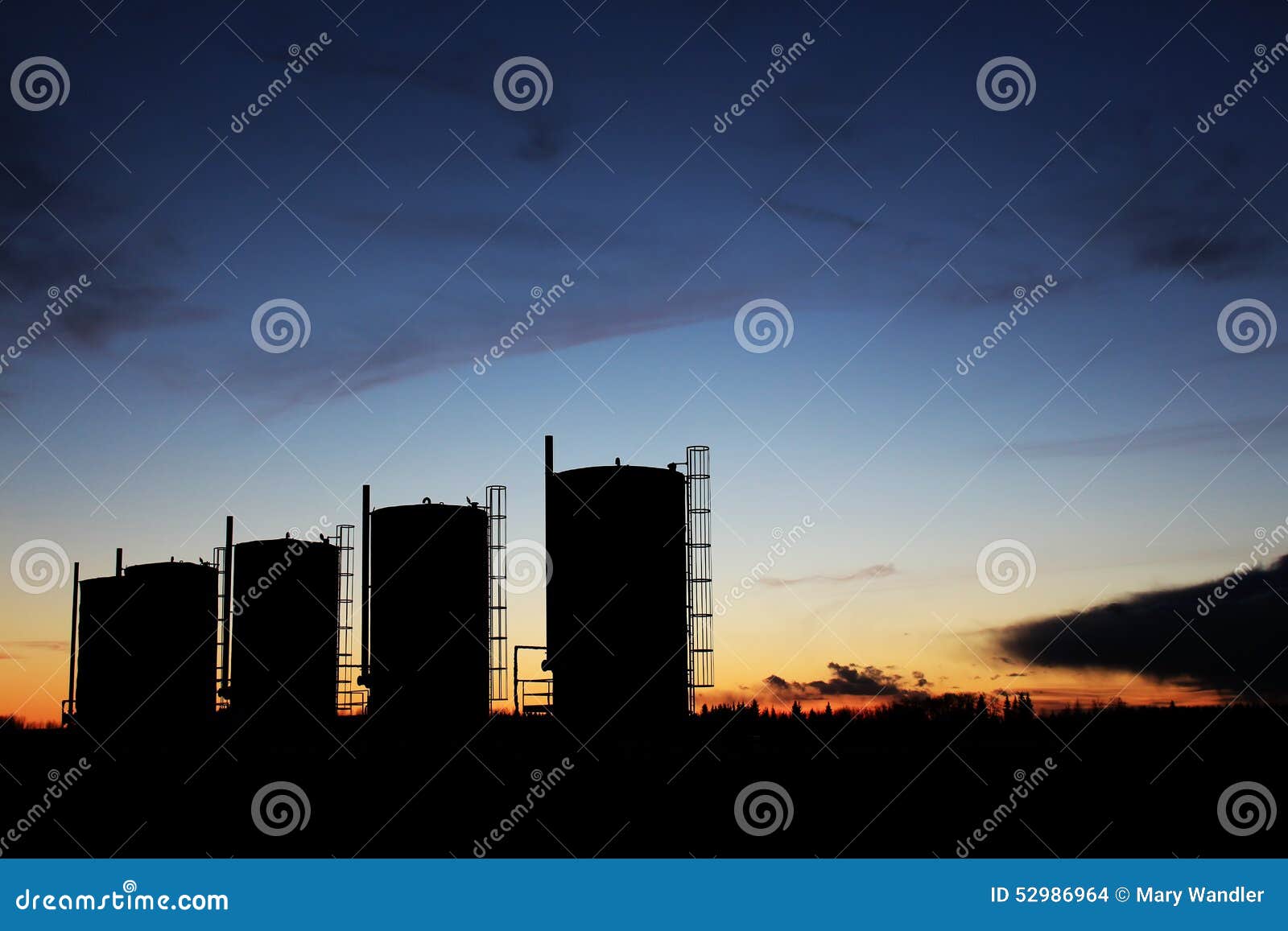 Silhouette Of Bitumen Tanks Under A Sunset Royalty-Free Stock Photo ...