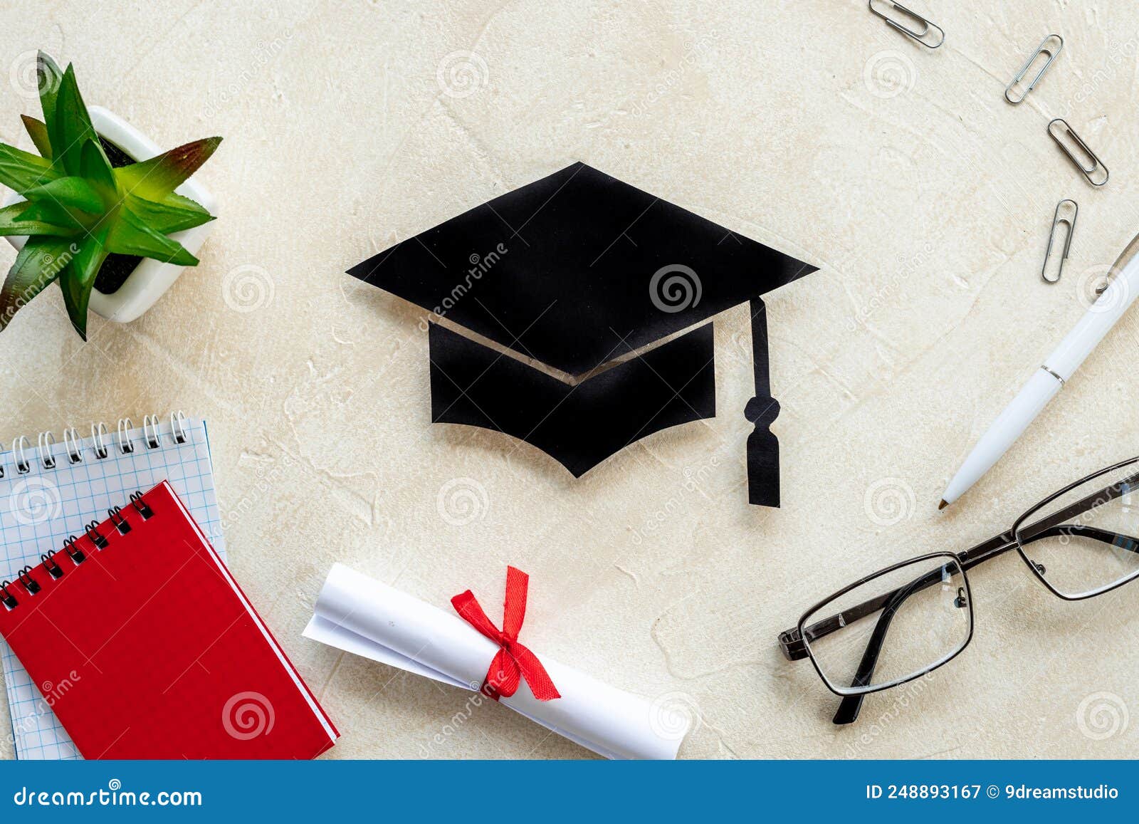 Black Academic Cap or Graduation Hat on Students Table, Top View Stock ...