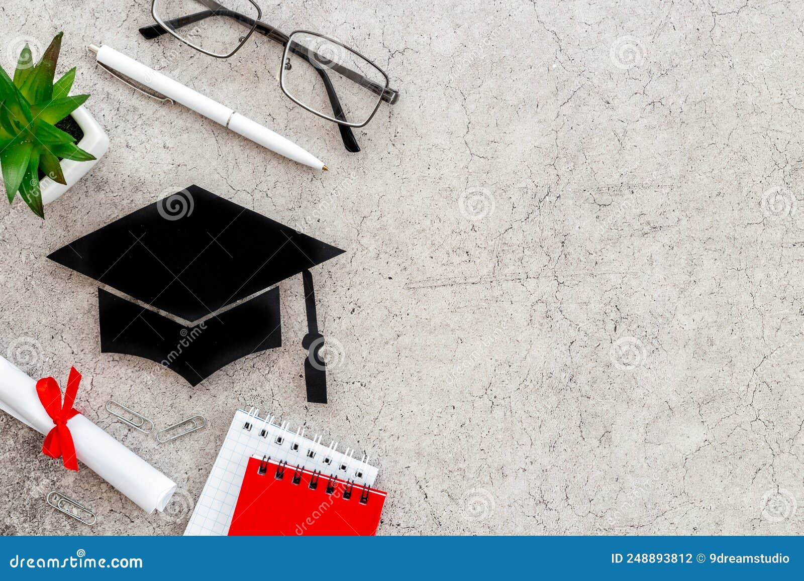 Black Academic Cap or Graduation Hat on Students Table, Top View Stock ...
