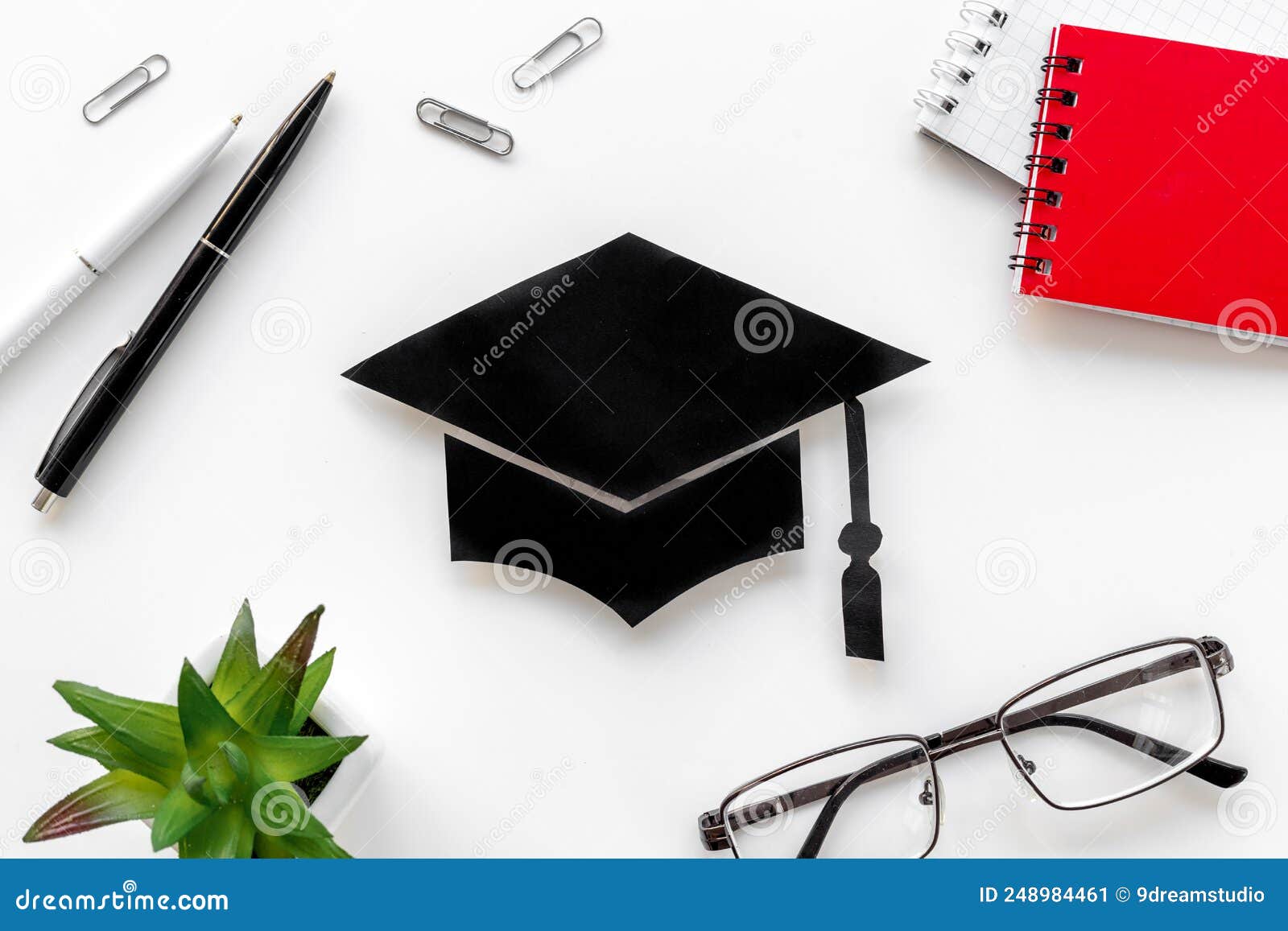 Black Academic Cap or Graduation Hat on Students Table, Top View Stock ...
