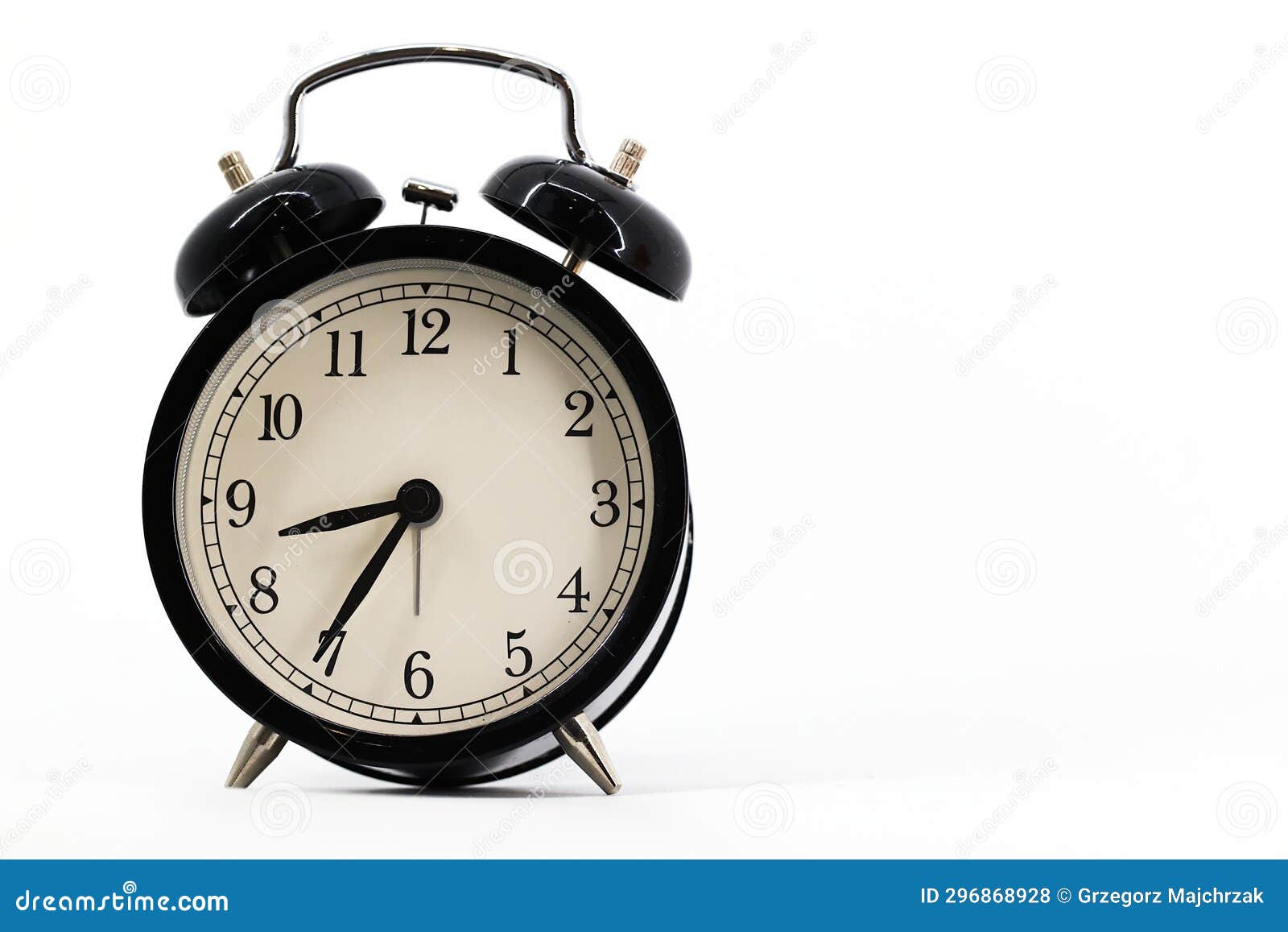 A Black Alarm Clock with Two Bells on Top, Chrome Handle, and Legs, Set ...