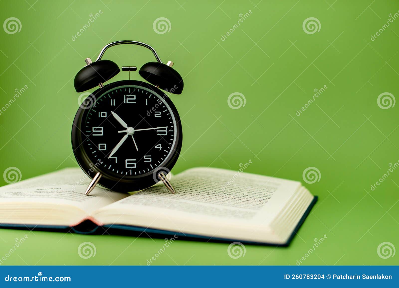 Black Alarm Clock Put on an Open Book, Reading Ideas and Reading Time ...