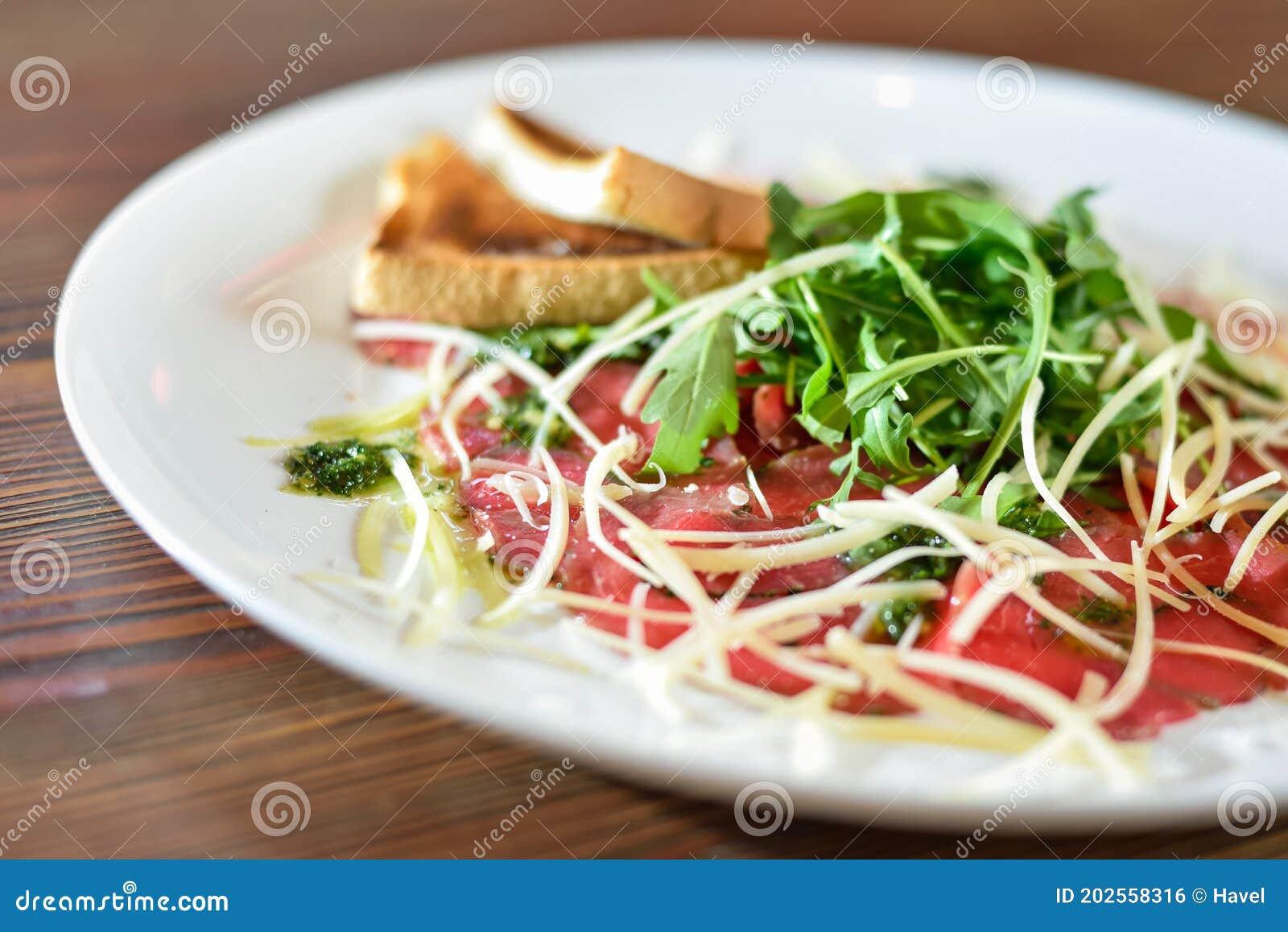 Black Angus Beef Carpaccio with Parmesan Cheese on a Plate Stock Photo ...