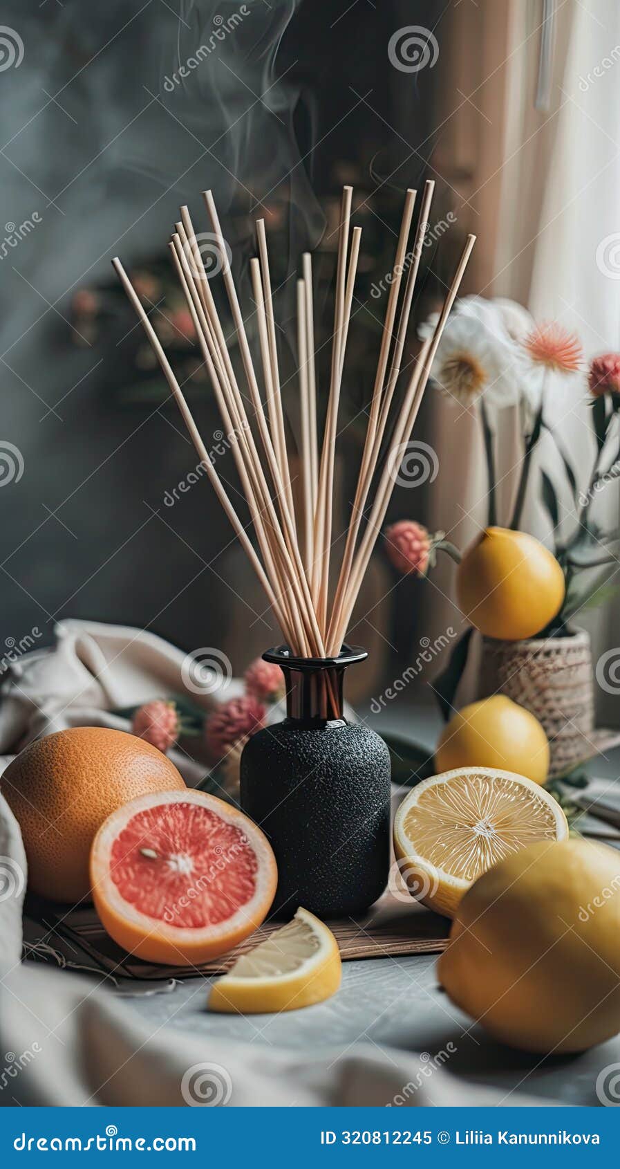 Black Background with Reed Diffusers Uniquely and Citrus Fruit on Stone, Black Round Stones in ...