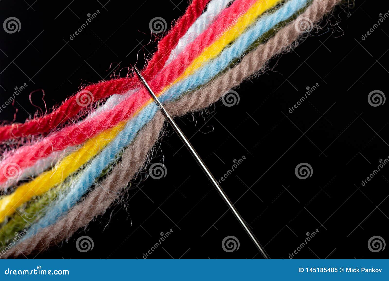 On a Black Background, Several Bright Multicolored Woolen Threads are ...