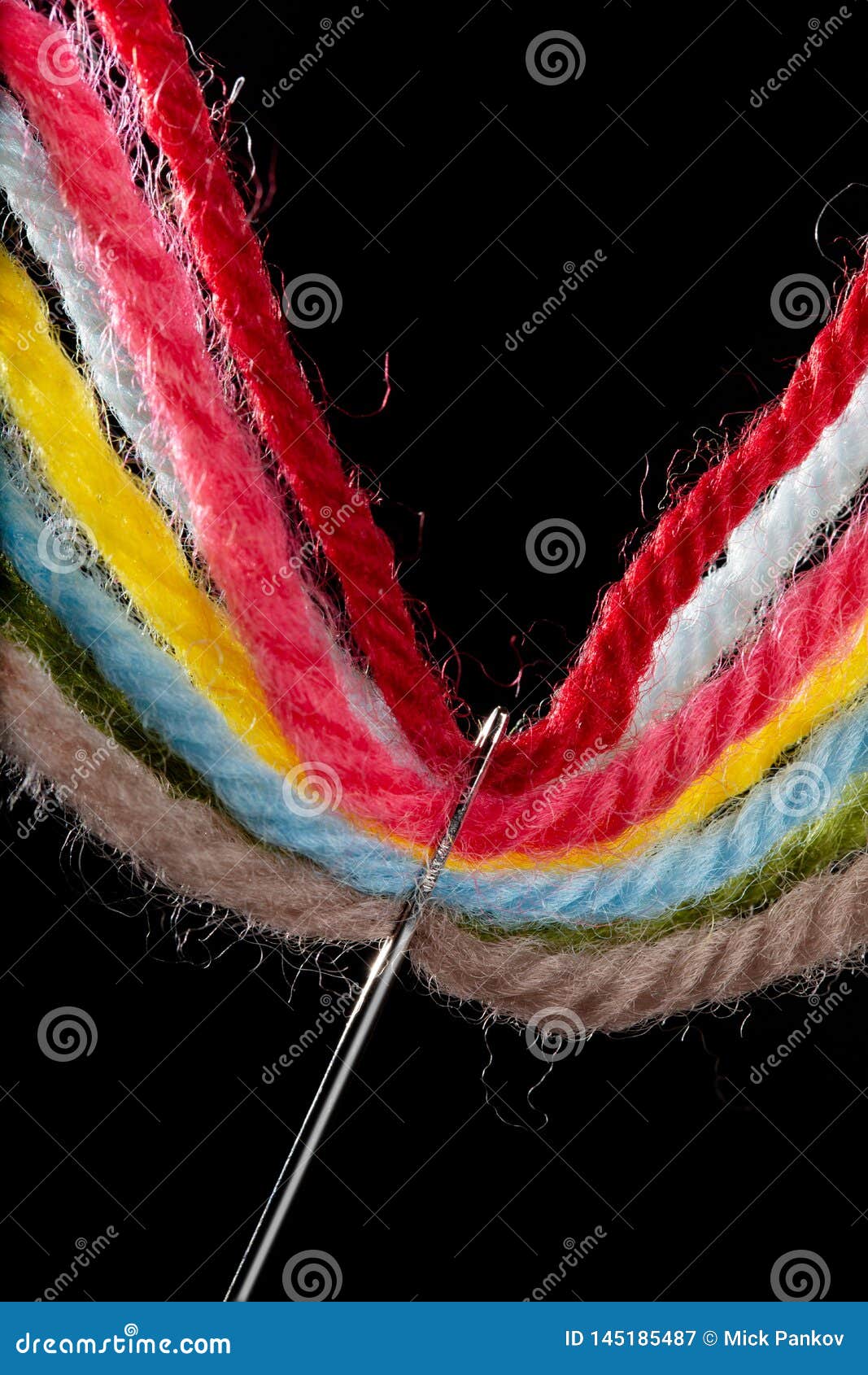 On a Black Background, Several Bright Multicolored Woolen Threads are ...