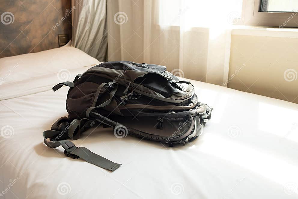 Black Backpack on the Bed of Hotel Room Horizontal Composition Stock ...