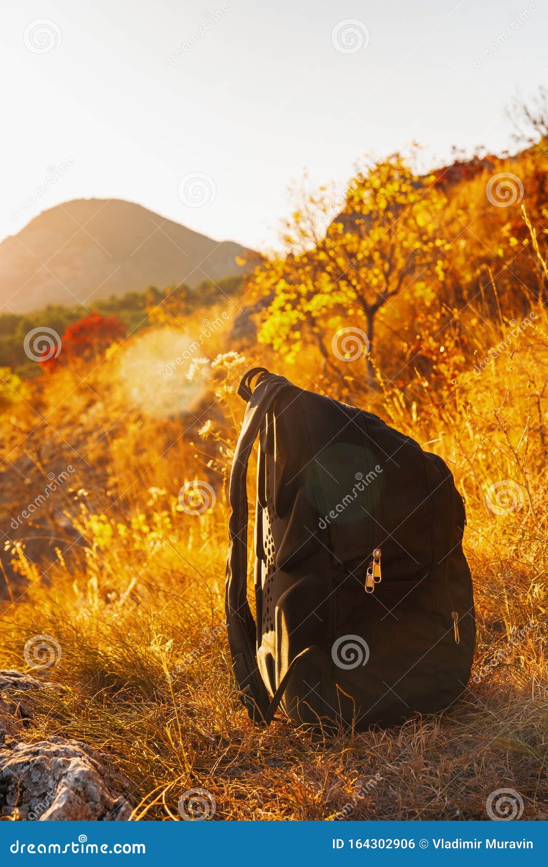 Black Backpack in the Mountains at Sunset Stock Photo - Image of ...