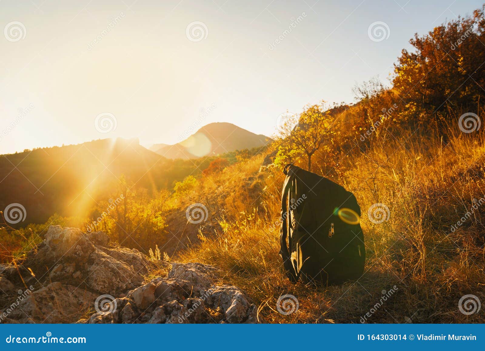 Black Backpack in the Mountains at Sunset Stock Photo - Image of ...