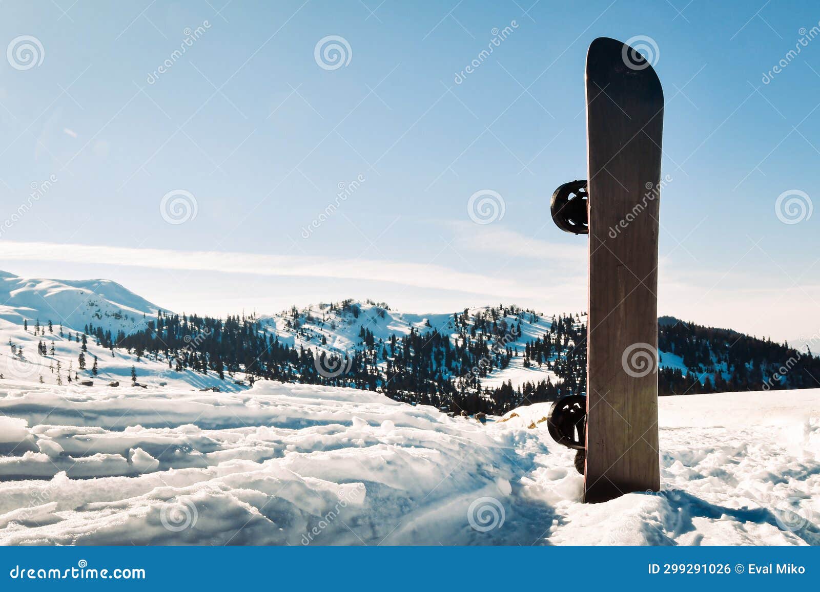 Black Base Snowboard in a Snow with White Mountains in the Background ...