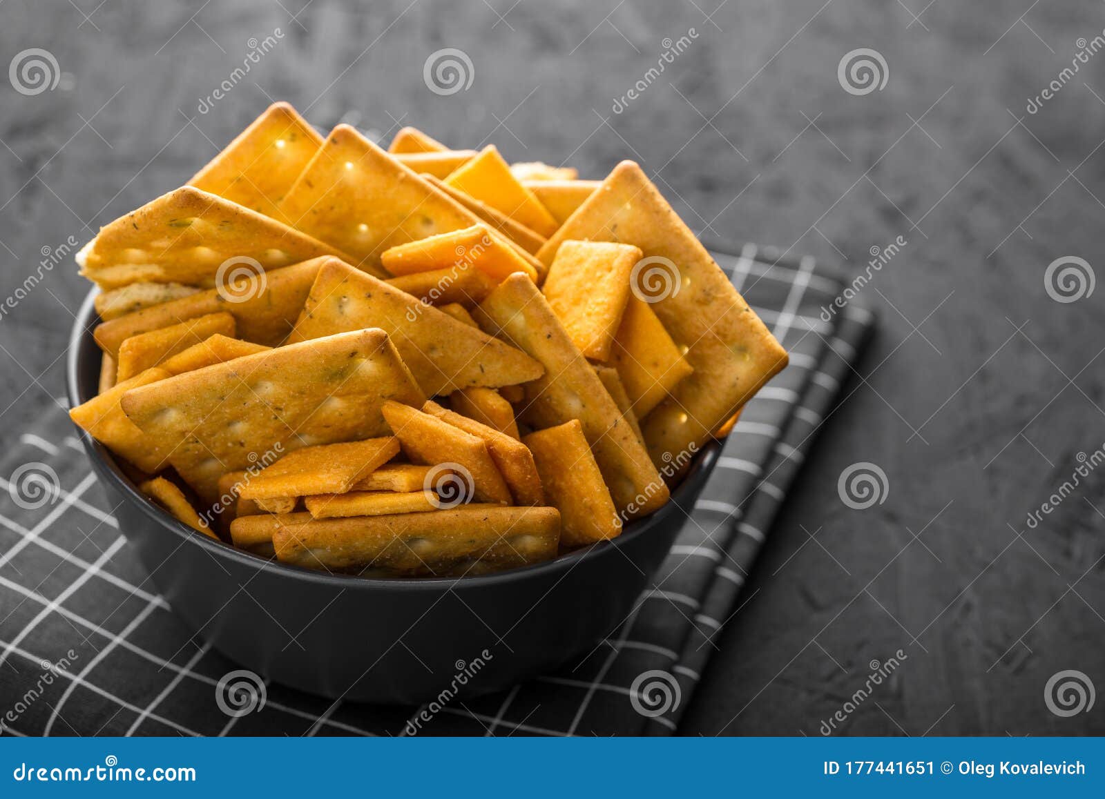 Black Bowl with Crackers on a Dark Concrete Background Stock Image ...