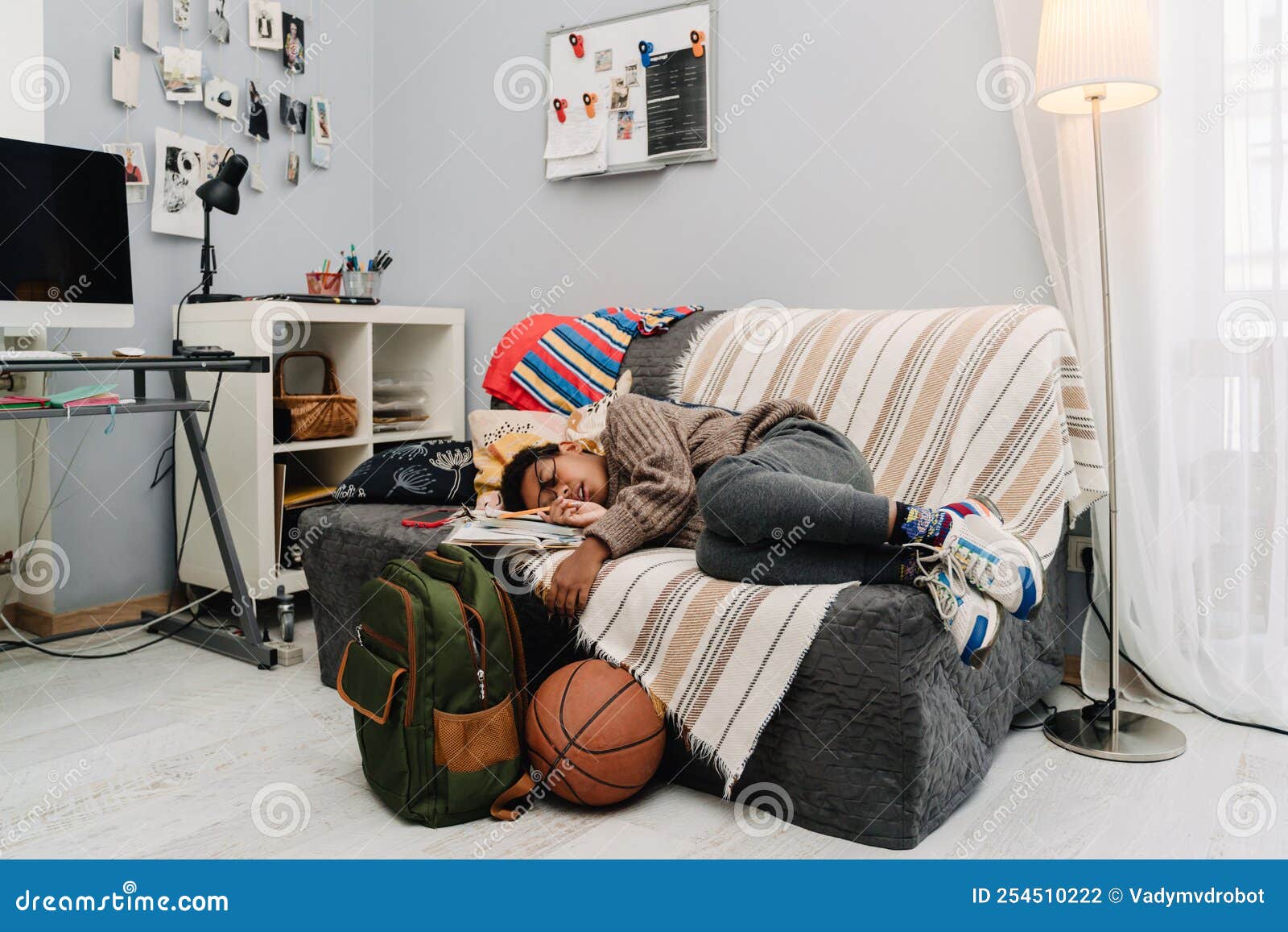 Black Boy Sleeping while Doing Homework on Sofa at Home Stock Photo ...