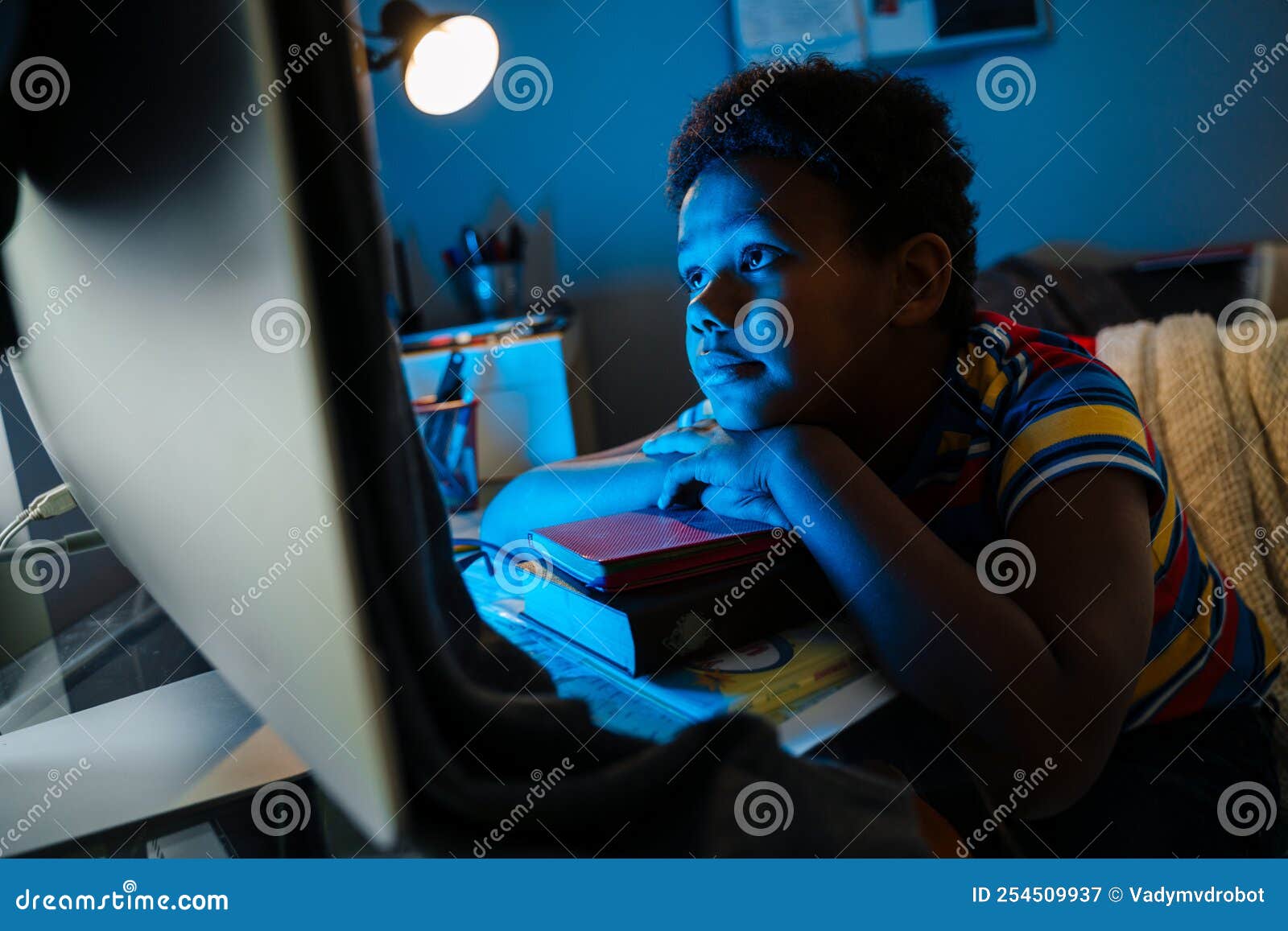 Black Boy Looking at Computer Screen while Doing Homework Stock Image ...