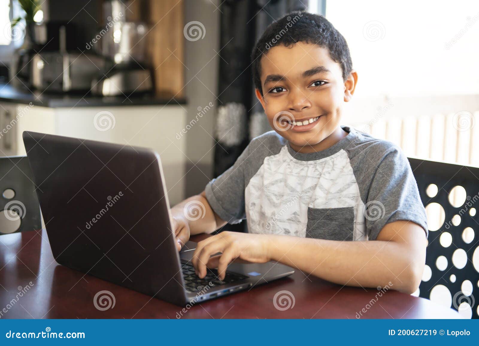 Black Boy Sitting Playing on a Laptop Computer at Home Stock Image ...