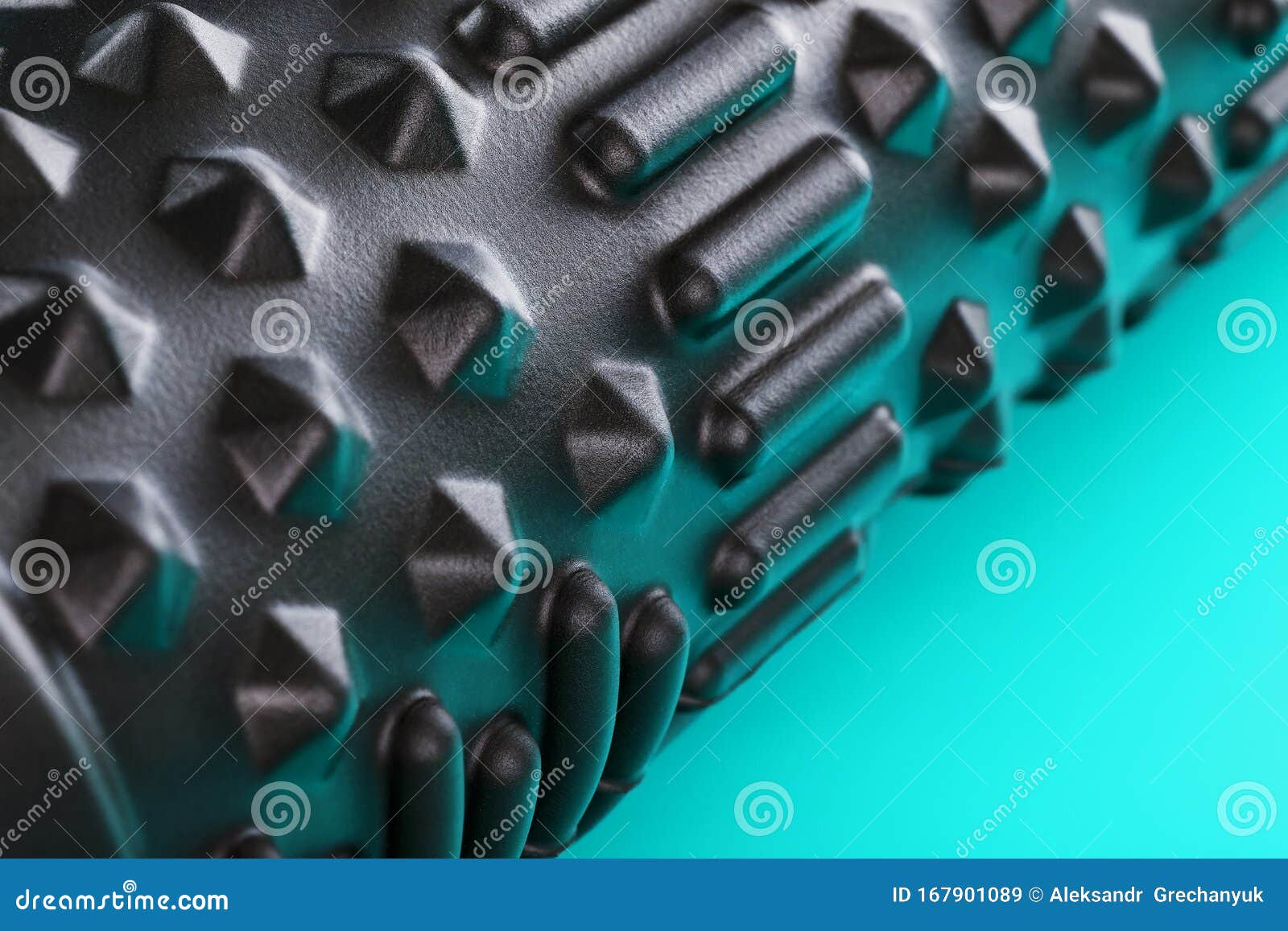 Black Bumpy Foam Massage Roller, Body Roller on Blue Background. F ...
