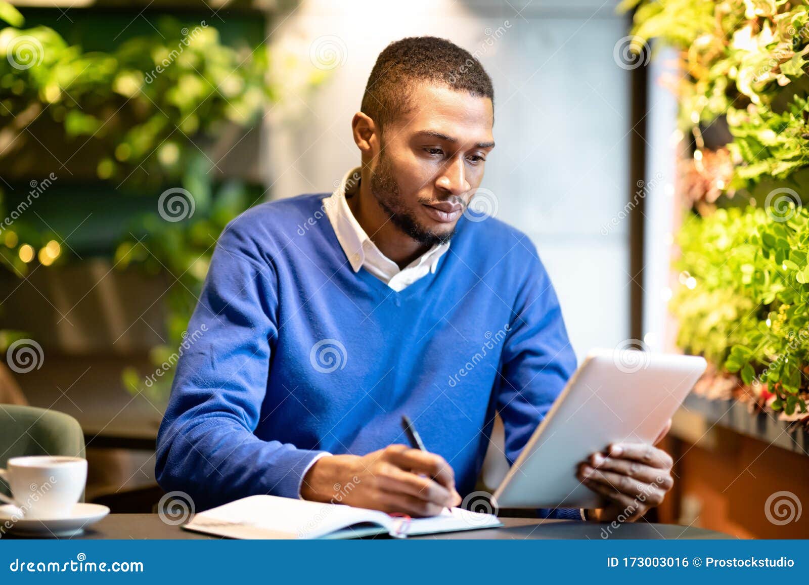 Black Business Guy Taking Notes in Notebook Holding Tablet Stock Photo ...