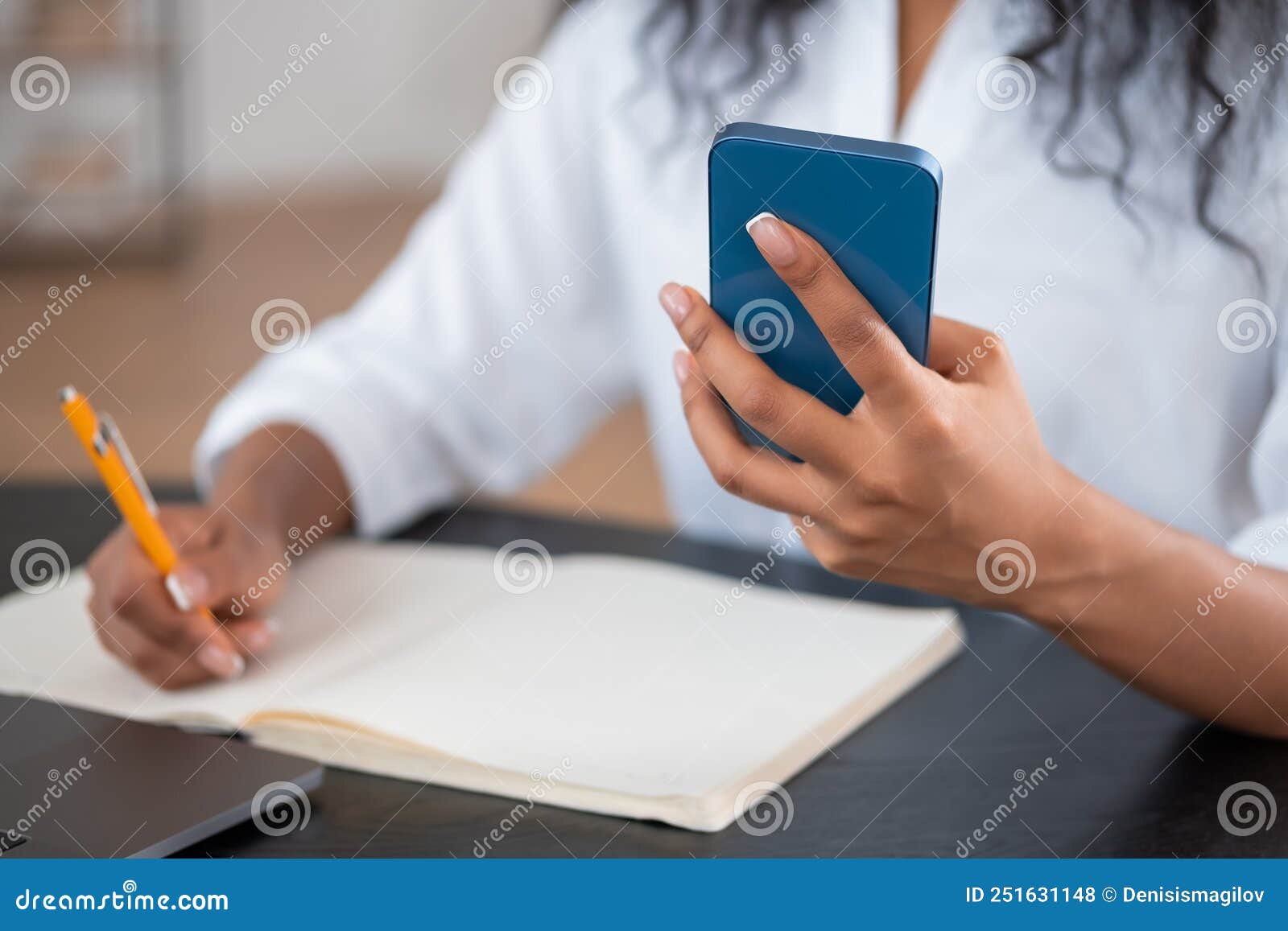 Black Businesswoman with Smartphone in Hand, Taking Notes Stock Photo ...