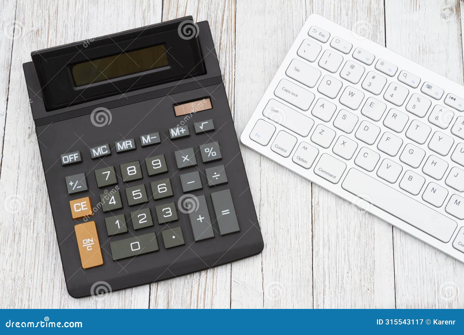 A Black Calculator with Computer Keyboard on Wood Desk Stock Image ...