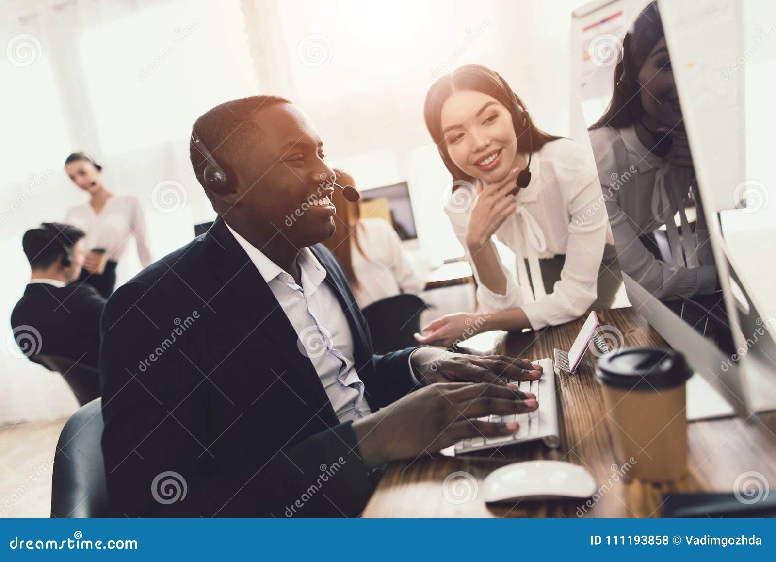 The Black Call Center Operator Looks at the Computer Screen and Laughs ...
