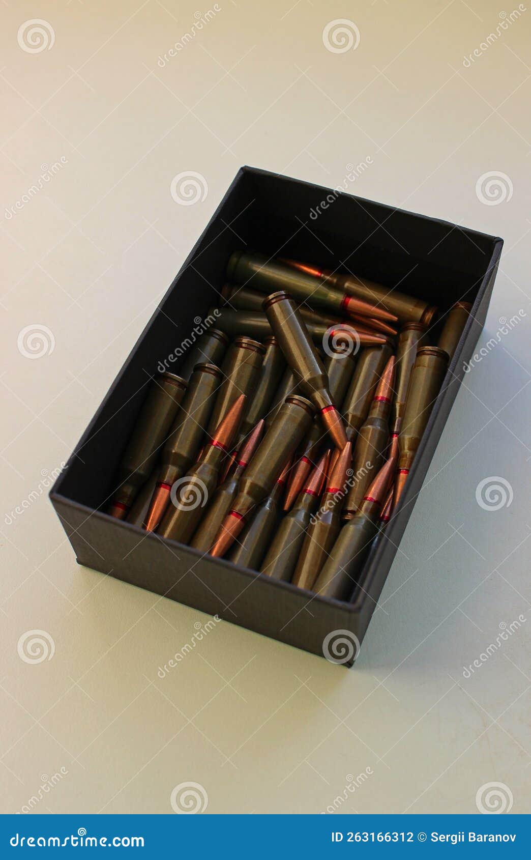 Black Case with Scattered Bullets on a White Surface Vertical Photo ...