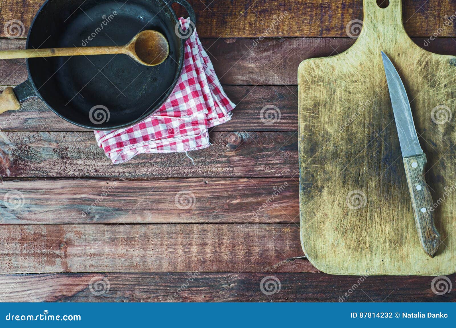 Black Cast Iron Pan and Cutting Board on Brown Wooden Surface Stock ...