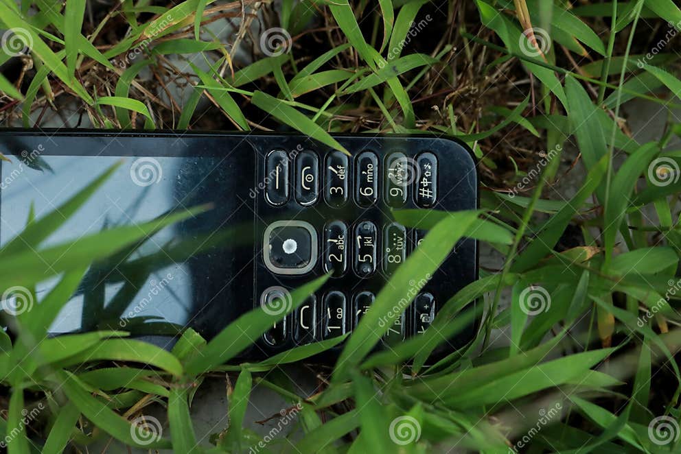 Black Cellphone with Physical Buttons on Grass Stock Image - Image of ...