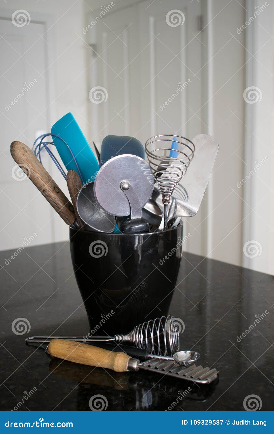 A Black Ceramic Container Holding Many Kitchen Utensils Stock Image ...