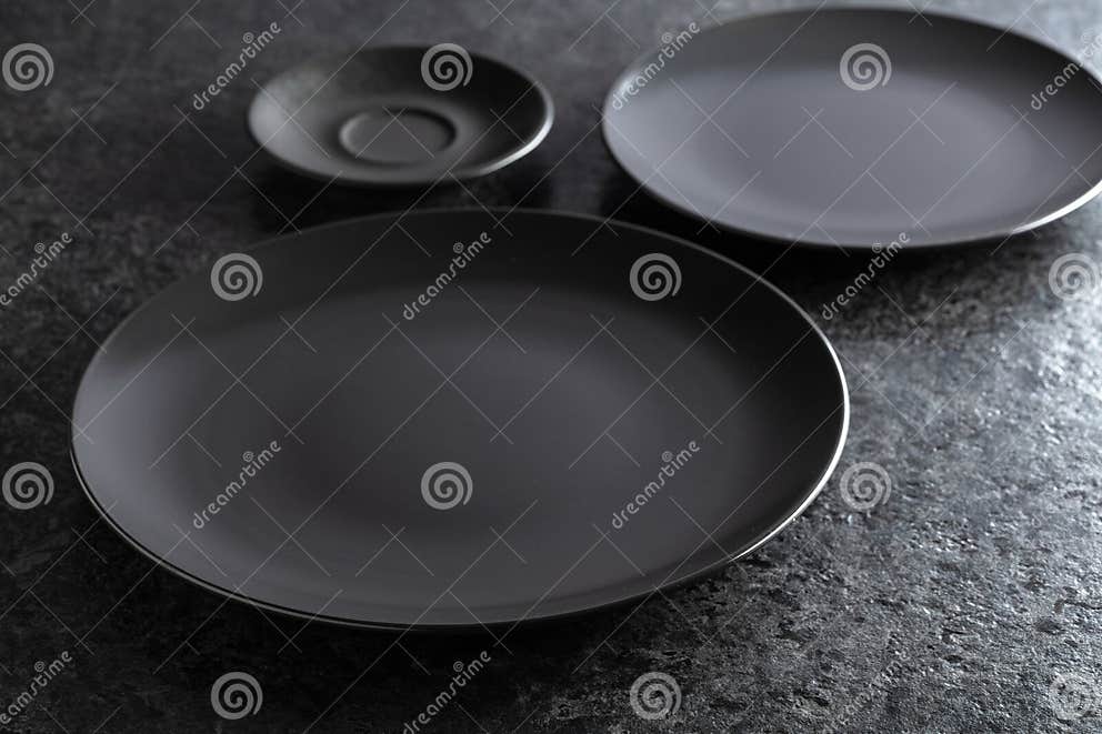 Black Ceramic Plates on a Black Stone Table Stock Image - Image of menu ...