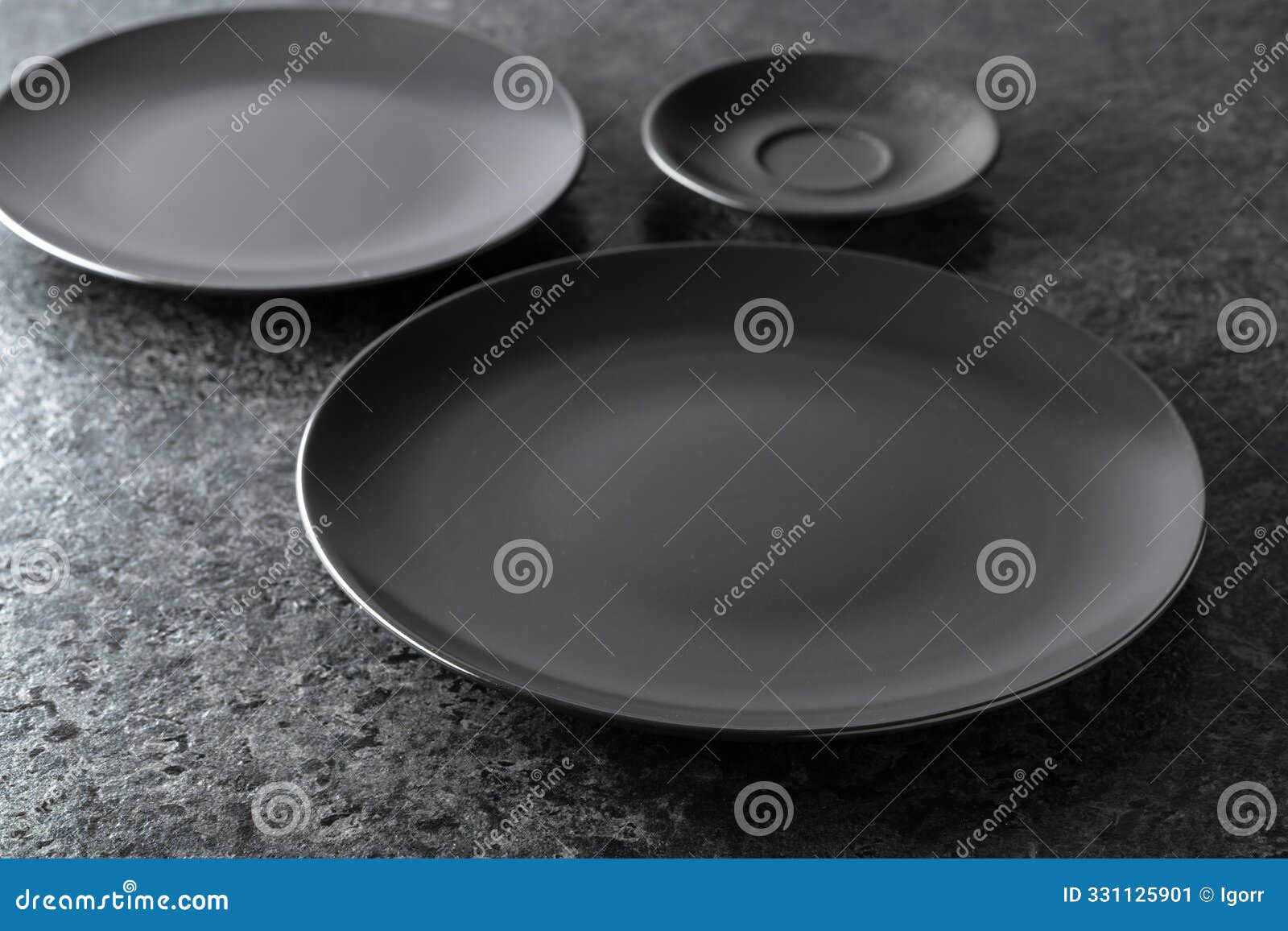 Black Ceramic Plates on a Black Stone Table Stock Image - Image of ...