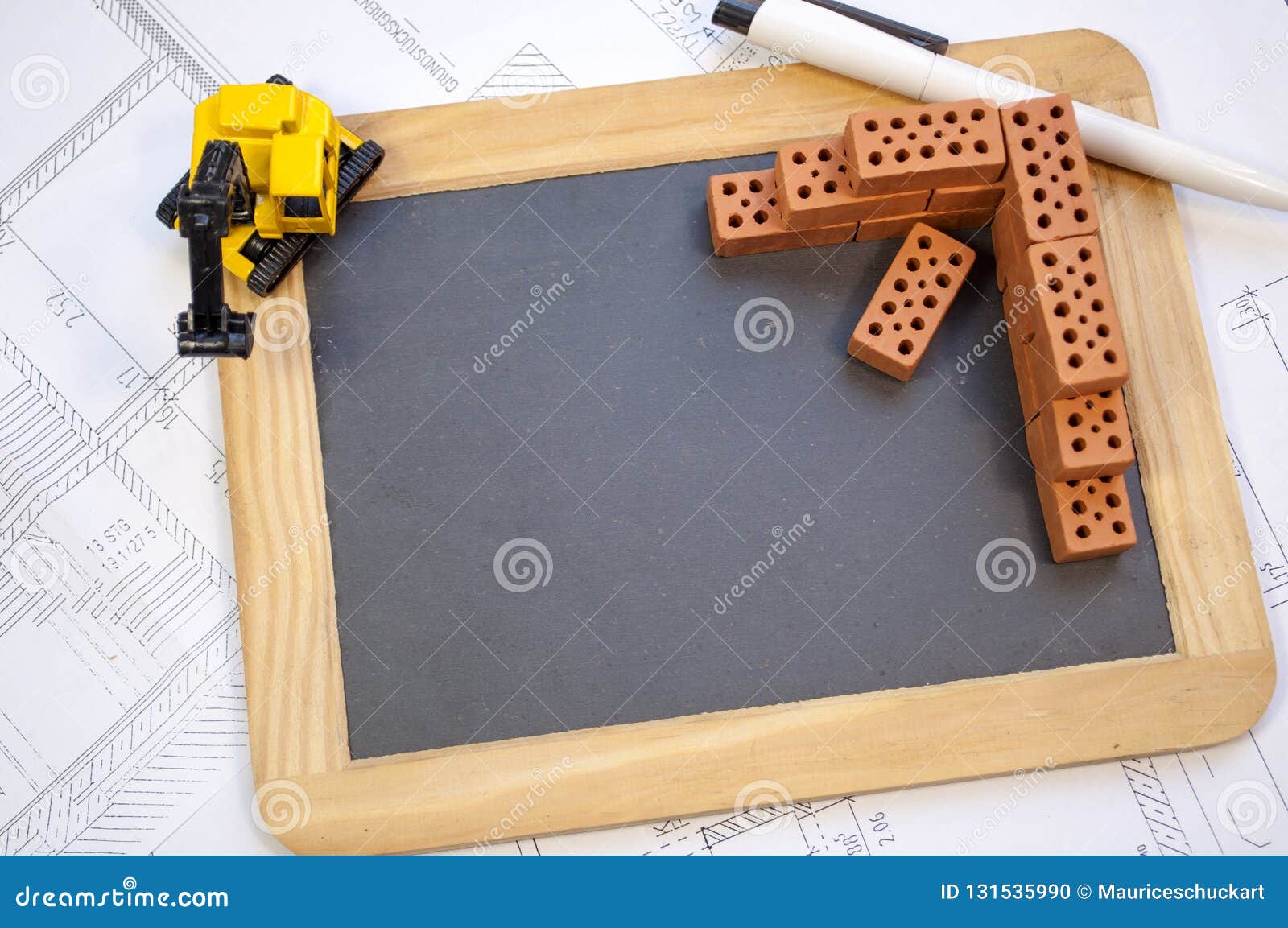 Chalkboard on a Construction Plan or Blueprint, Small Clinker Bricks ...