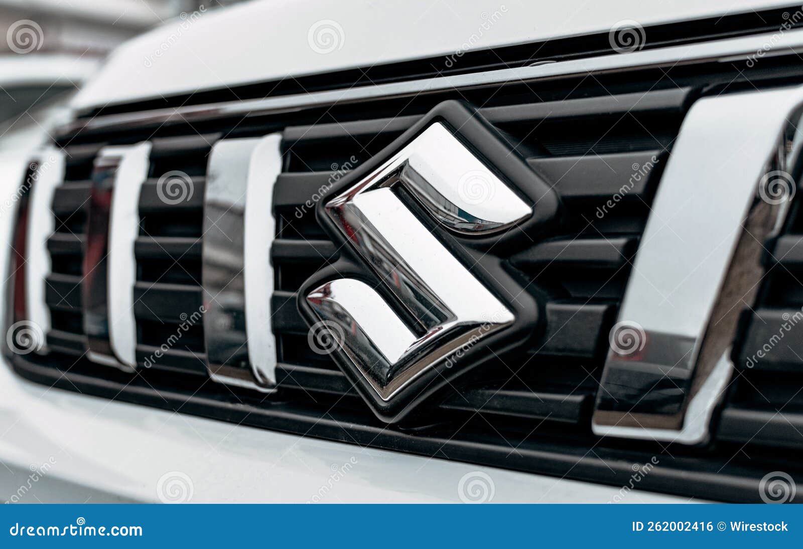 Black and Chrome Trim Around Suzuki Logo on Front of a Silver Car ...