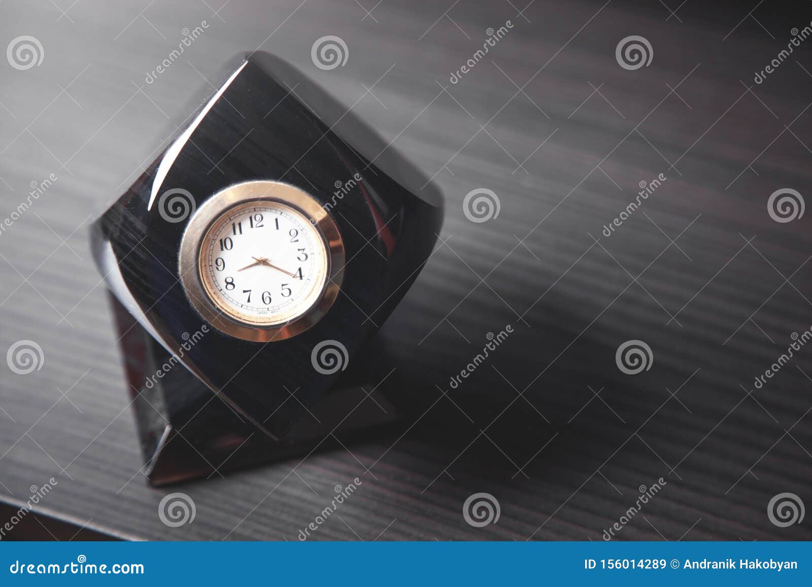 Black clock on wooden desk stock image. Image of time - 156014289