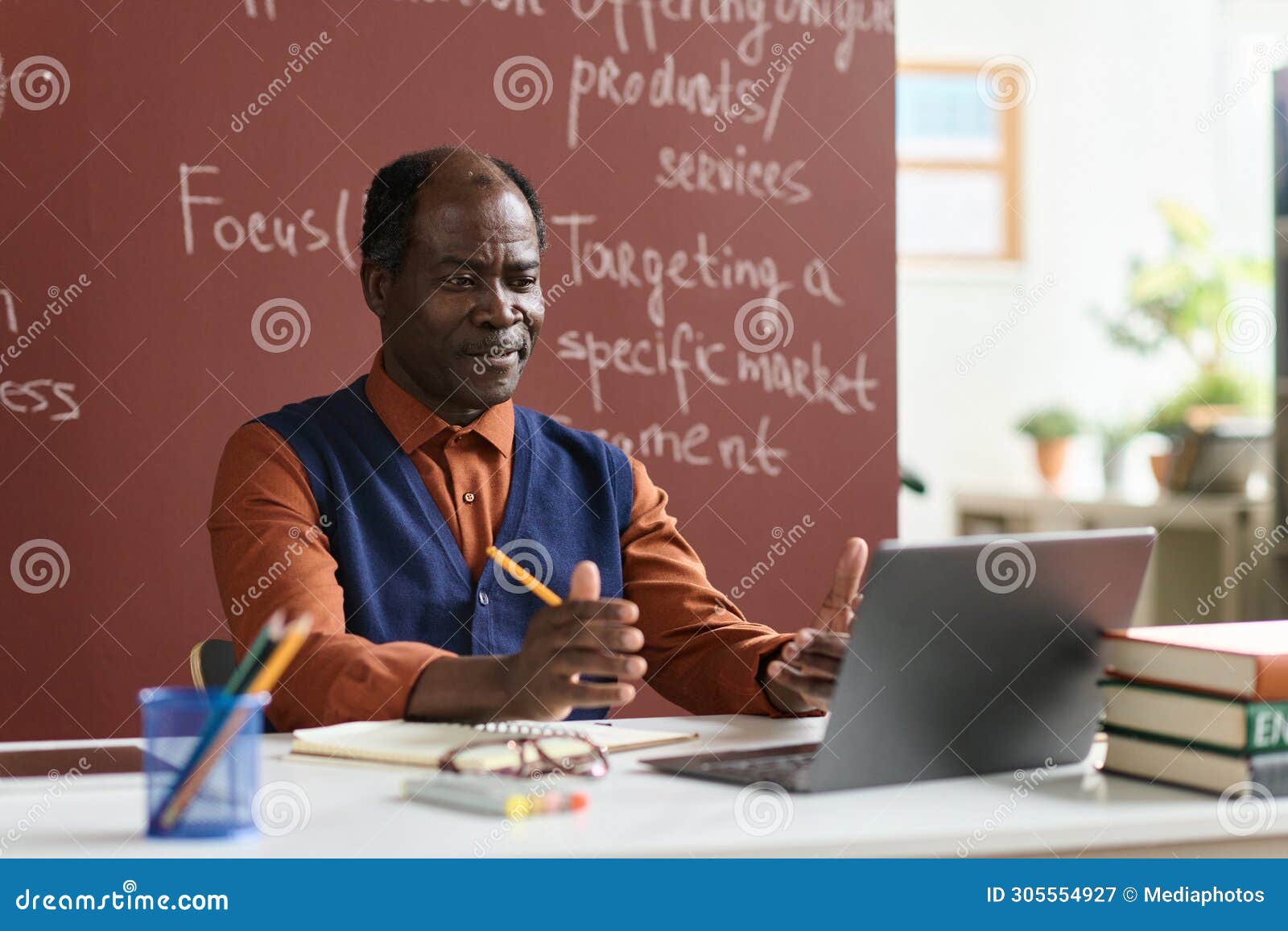 Black College Professor Sitting at Desk Stock Image - Image of ...