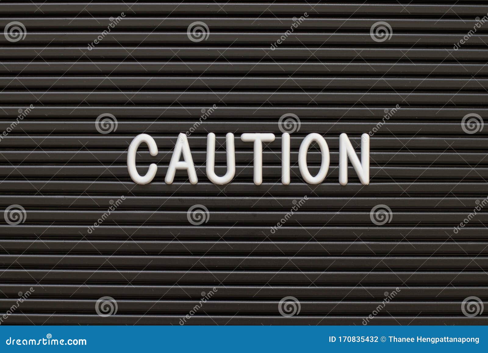 Black Felt Letter Board with White Alphabet in Word Caution Background ...