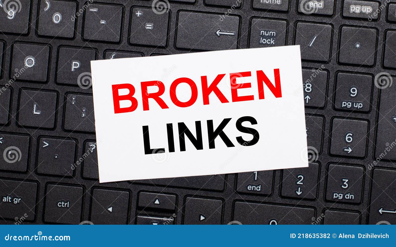 On a Black Computer Keyboard There is a White Card with the Text BROKEN ...