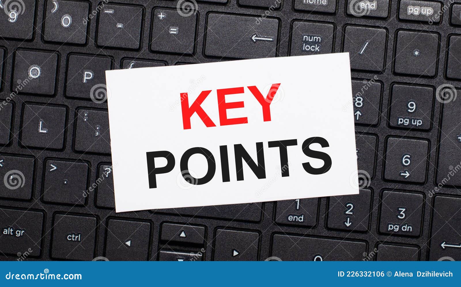 On a Black Computer Keyboard There is a White Card with the Text KEY ...