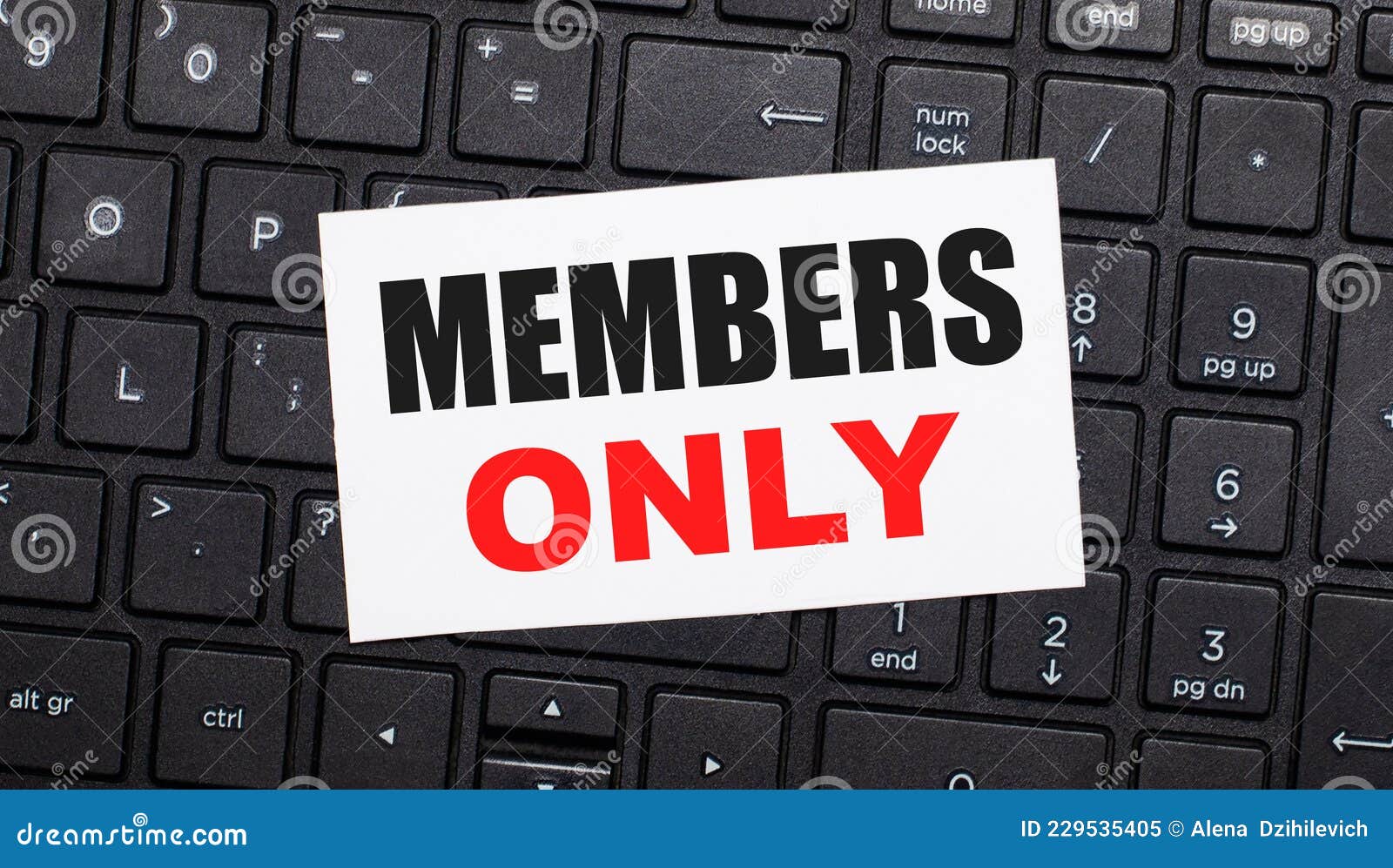 On a Black Computer Keyboard There is a White Card with the Text ...