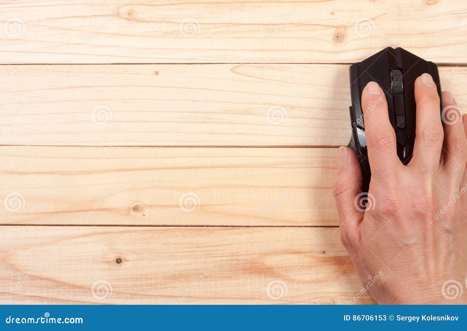 Black Computer Mouse with a Hand on a Light Wooden Background with Copy ...