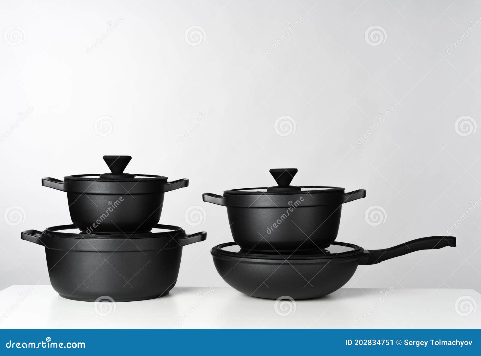 Black Cooking Pots on Grey Background Front View Stock Image - Image of ...