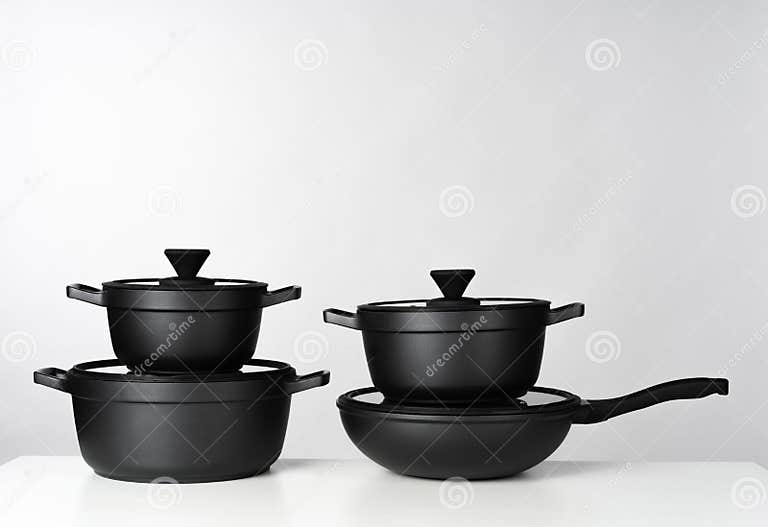 Black Cooking Pots on Grey Background Front View Stock Image - Image of ...