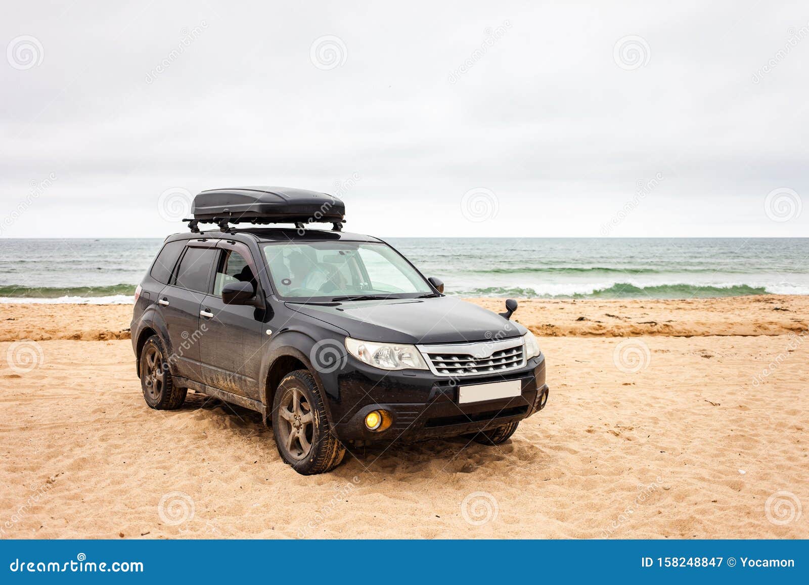 Black Crossover with Trunk Box at Sand Beach in Summer Stock Image ...