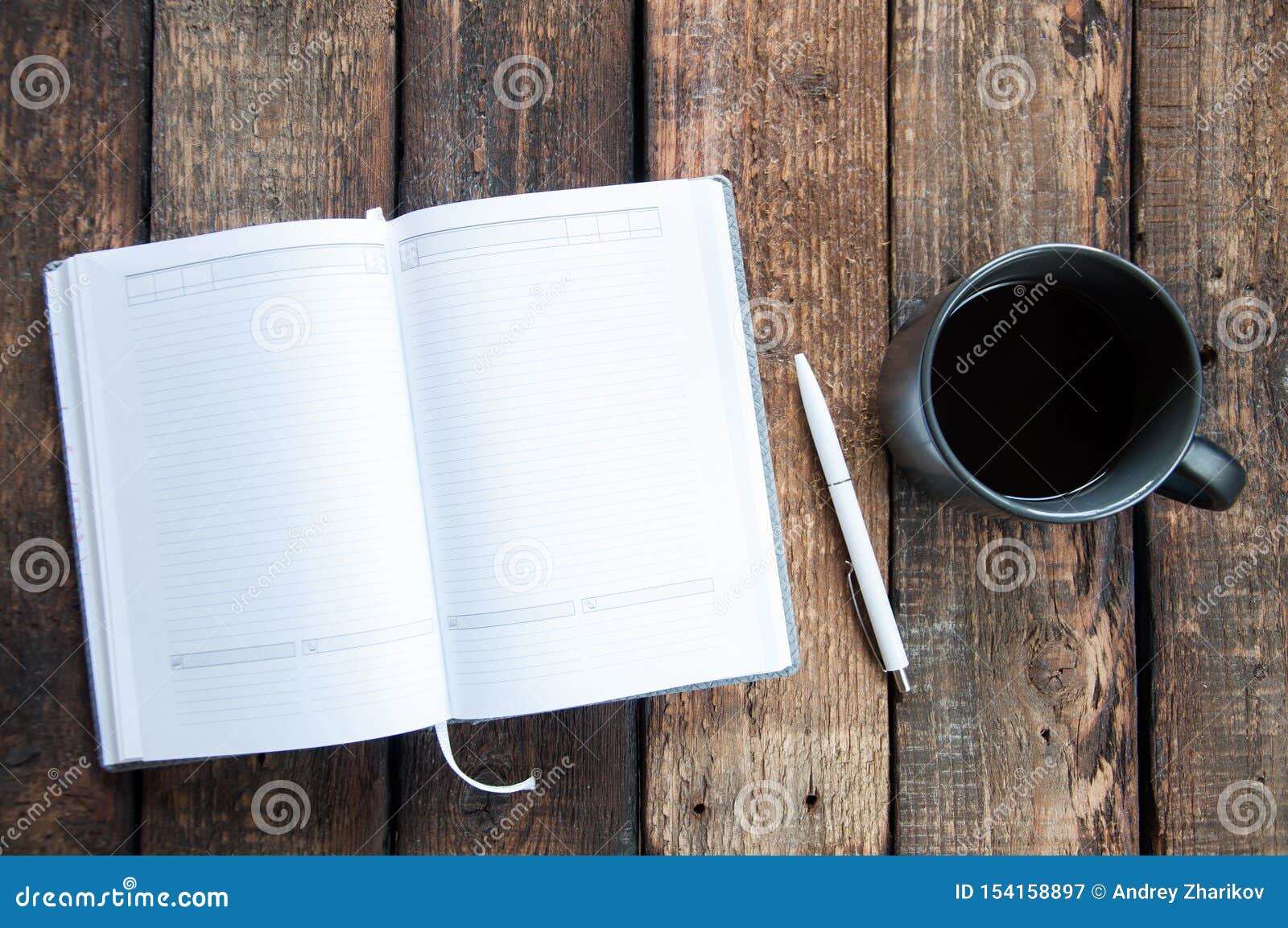 Black Cup with Coffee and Open Notepad on a Wooden Table. Brown Wooden ...