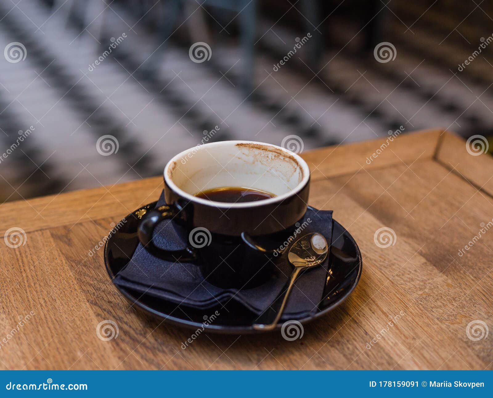 A Black Cup of Half Full Espresso Coffee on the Wooden Table in the ...