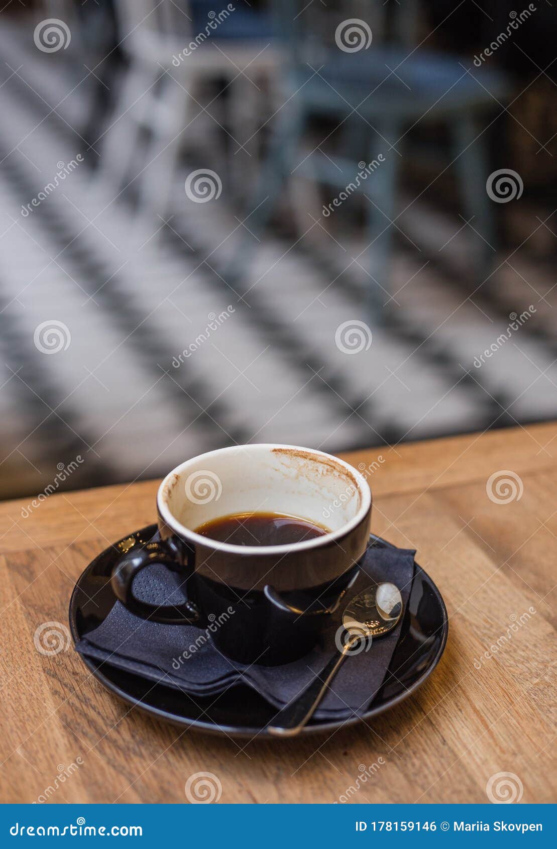 A Black Cup of Half Full Espresso Coffee on the Wooden Table in the ...