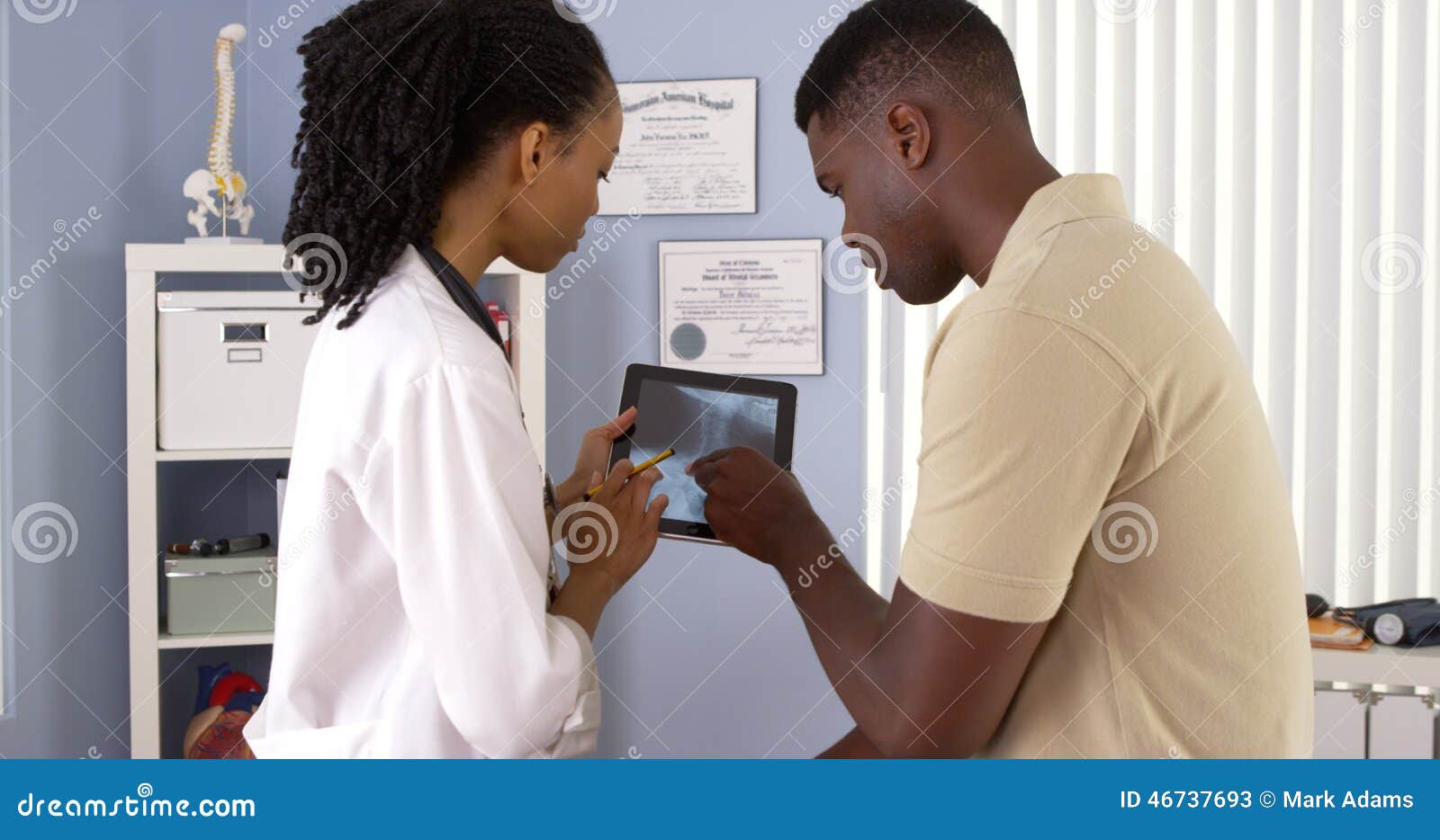Black Doctor Using Tablet Computer To Share X Ray with Patient Stock ...