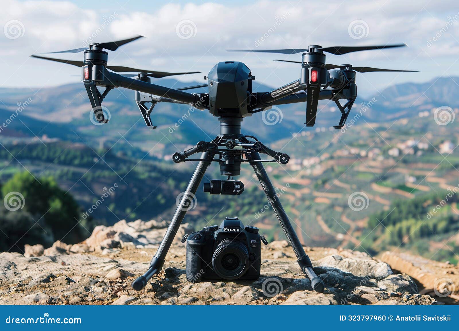 A Black Drone with a Camera Attached Sits on a Tripod on a Mountaintop ...