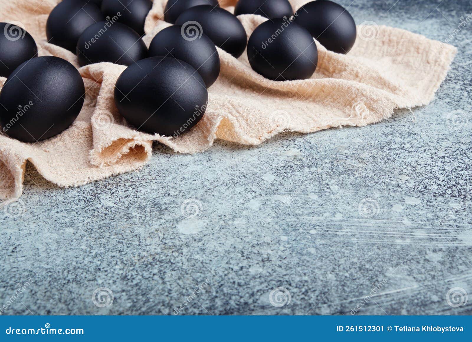 Black Easter Eggs on a Linen Napkin on a Blue Texture Table. Easter ...