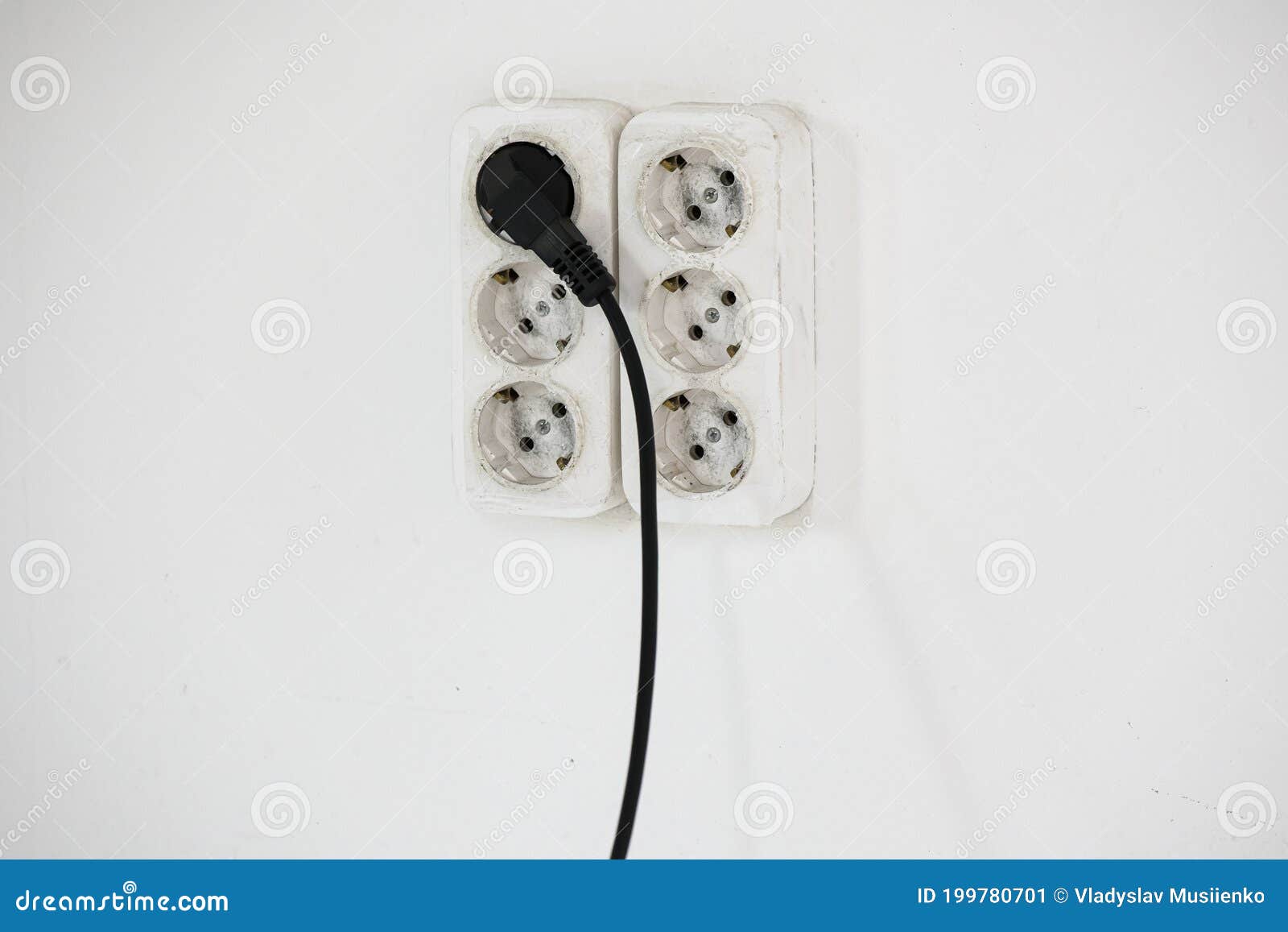 Black Electrical Wire With Plug Plugged Into Socket And Five Free ...