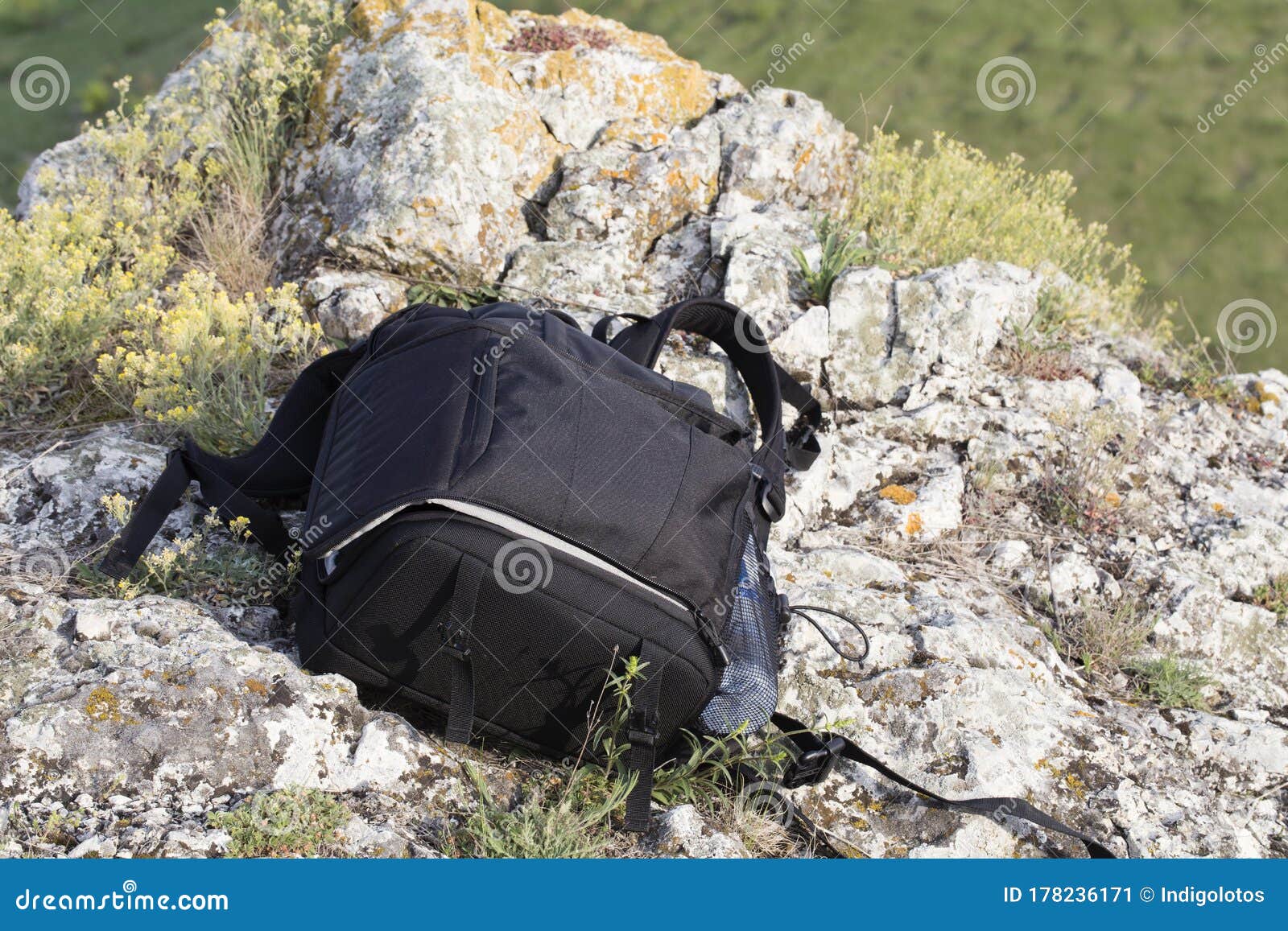 Black Fabric Rucksack on the Rock Stock Image - Image of yellow, stone ...